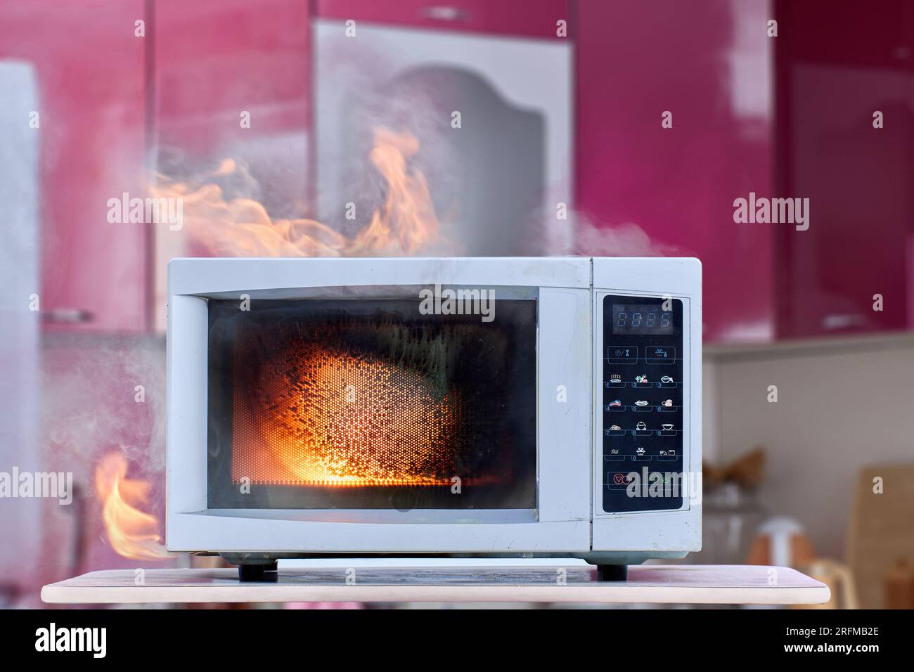 Electric fire from malfunctioning microwave with smoke and open flames ...