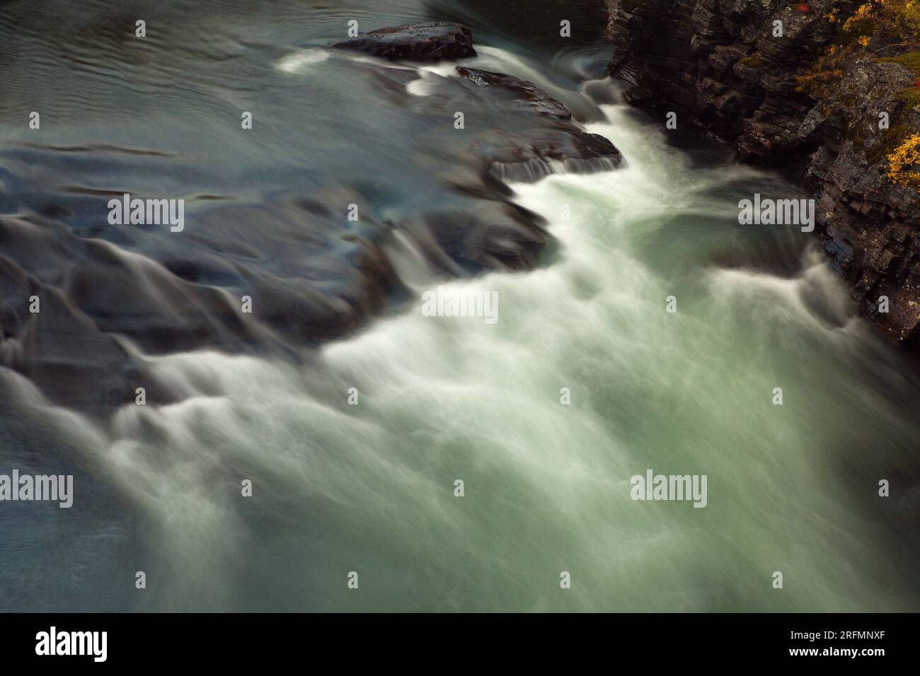 Rapids in the rocky river, surrounded by rocks and cliffs. Different ...