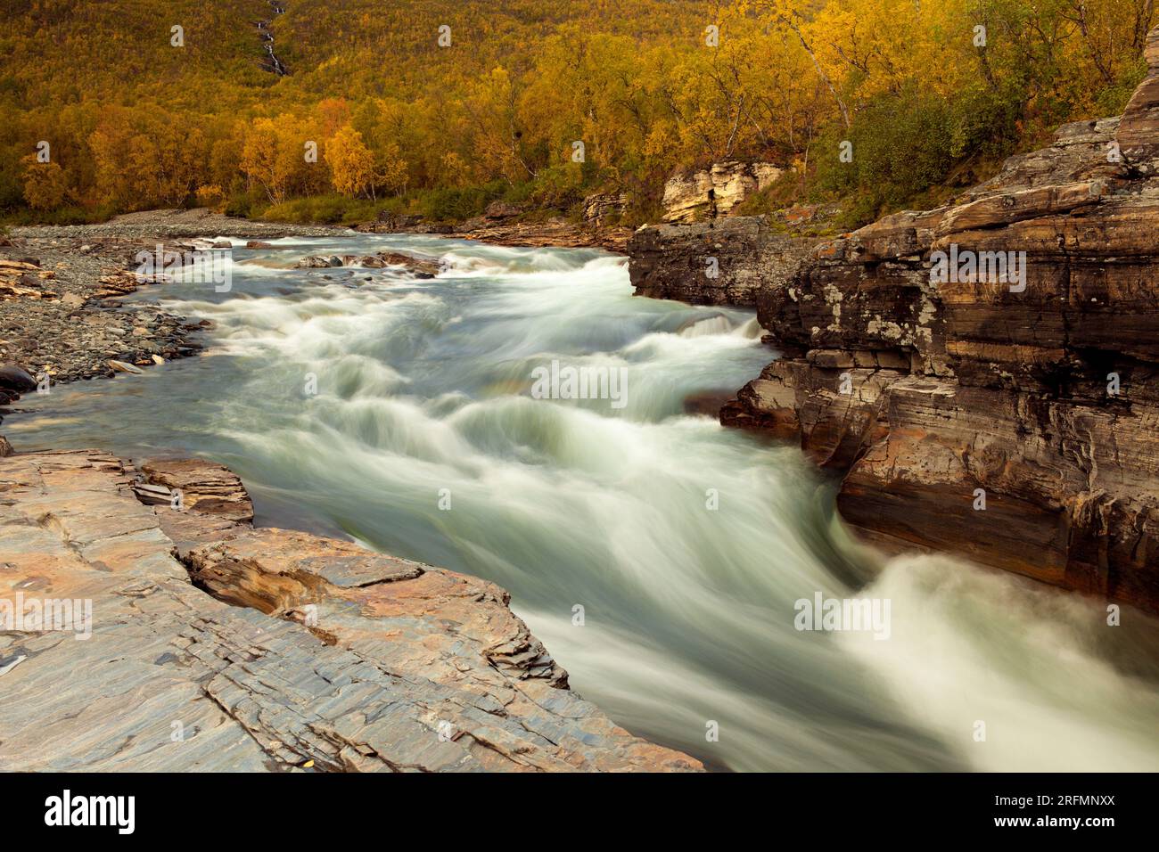 Rapids in the rocky river, surrounded by rocks and cliffs. Different ...