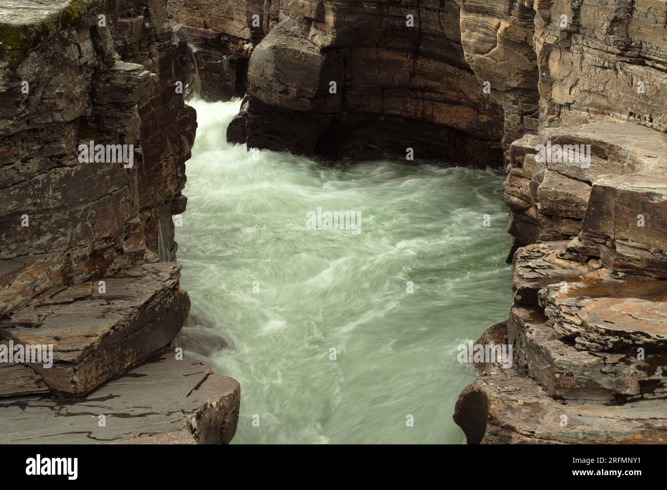 Rapids in the rocky river, surrounded by rocks and cliffs. Different ...