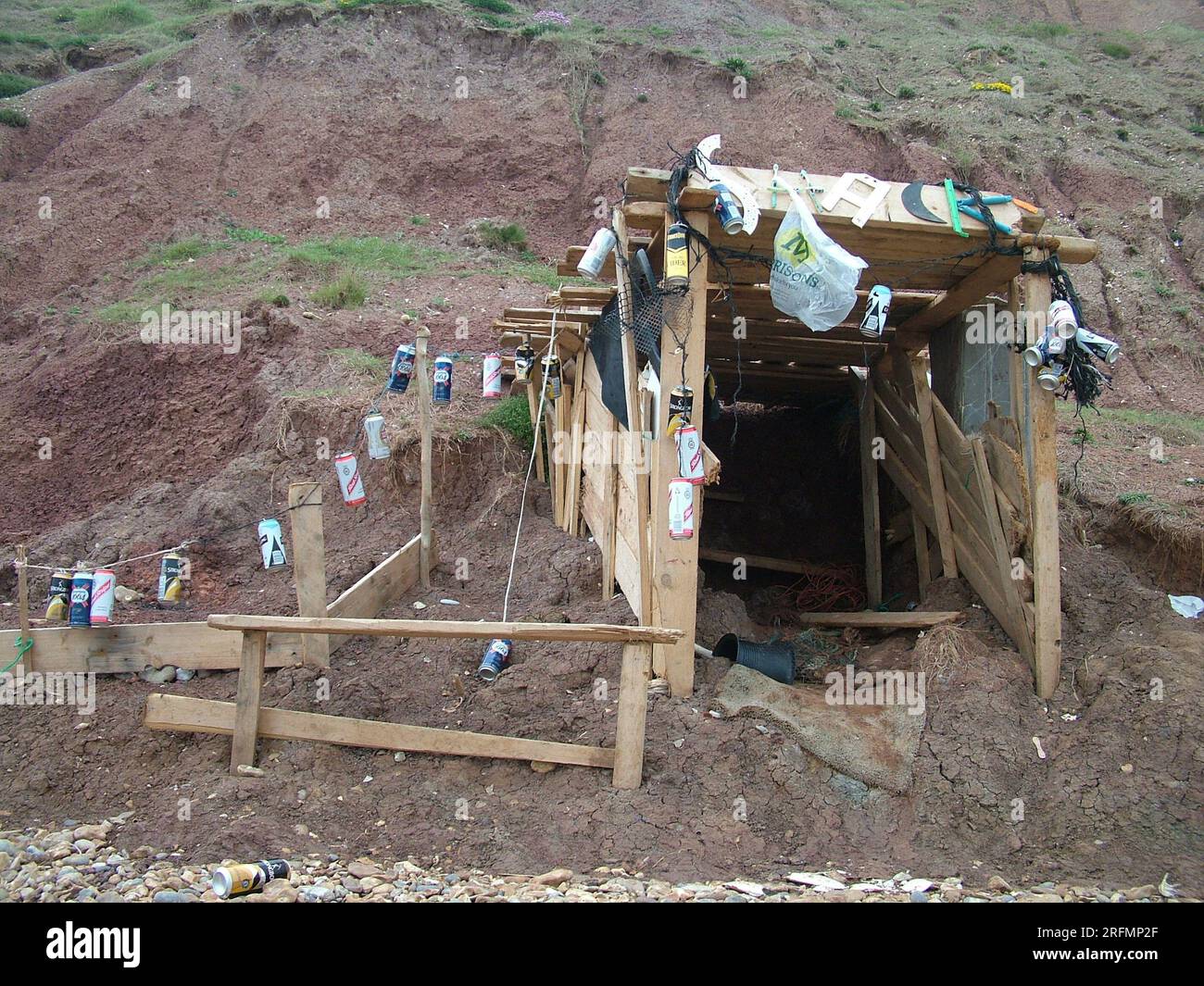 Shack built from driftwood at the base of an unstable cliff on the Isle ...