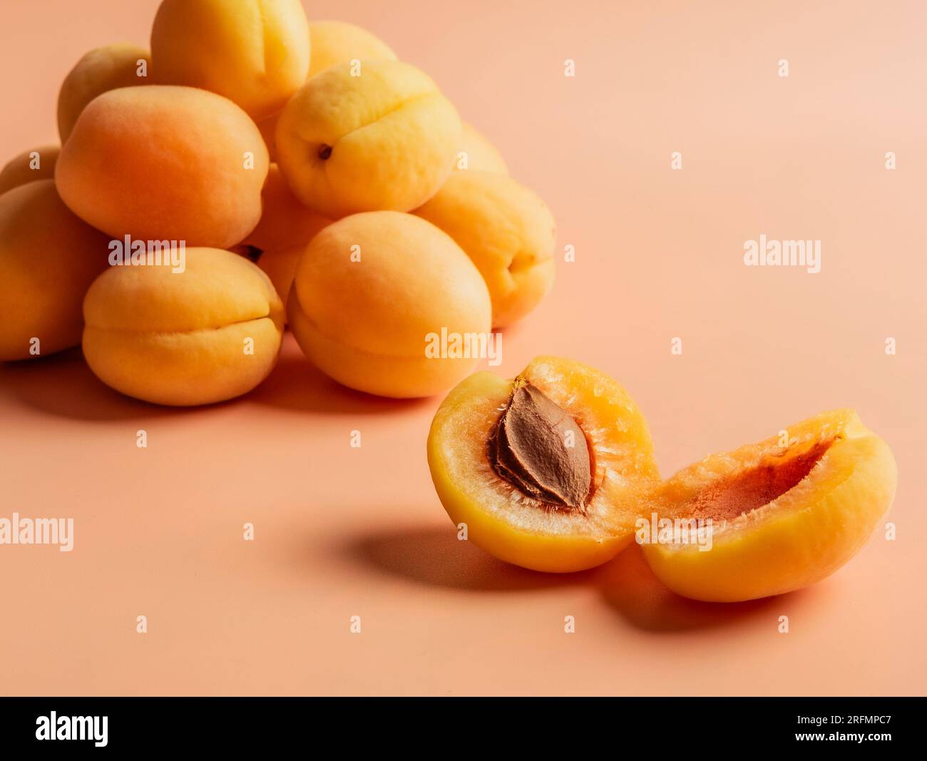 Tower of apricots on a beige background Stock Photo - Alamy