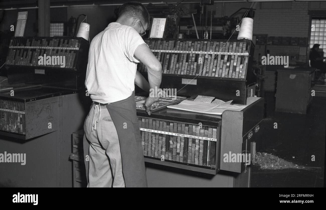 1950s, historical, male worker wearing a canvas work apron at a letter ...