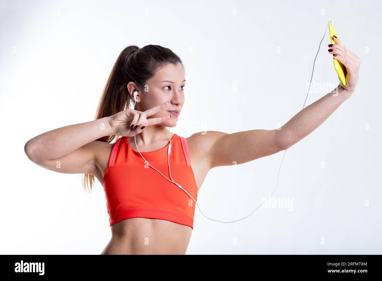 In her colorful sports attire, an Eastern-featured woman clicks a ...