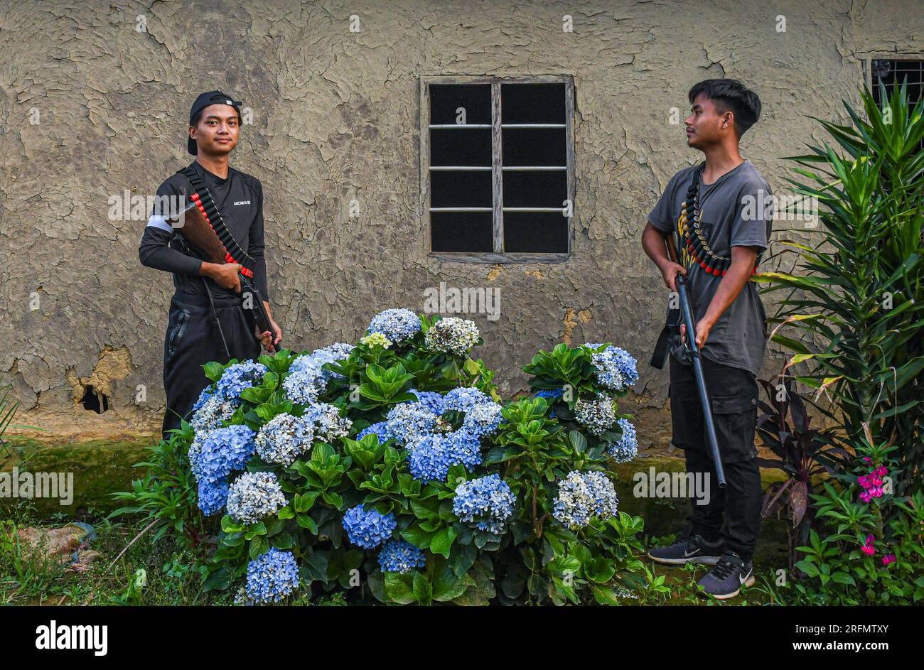 Armed youths from the Kuki tribe pose for a photo during their ...