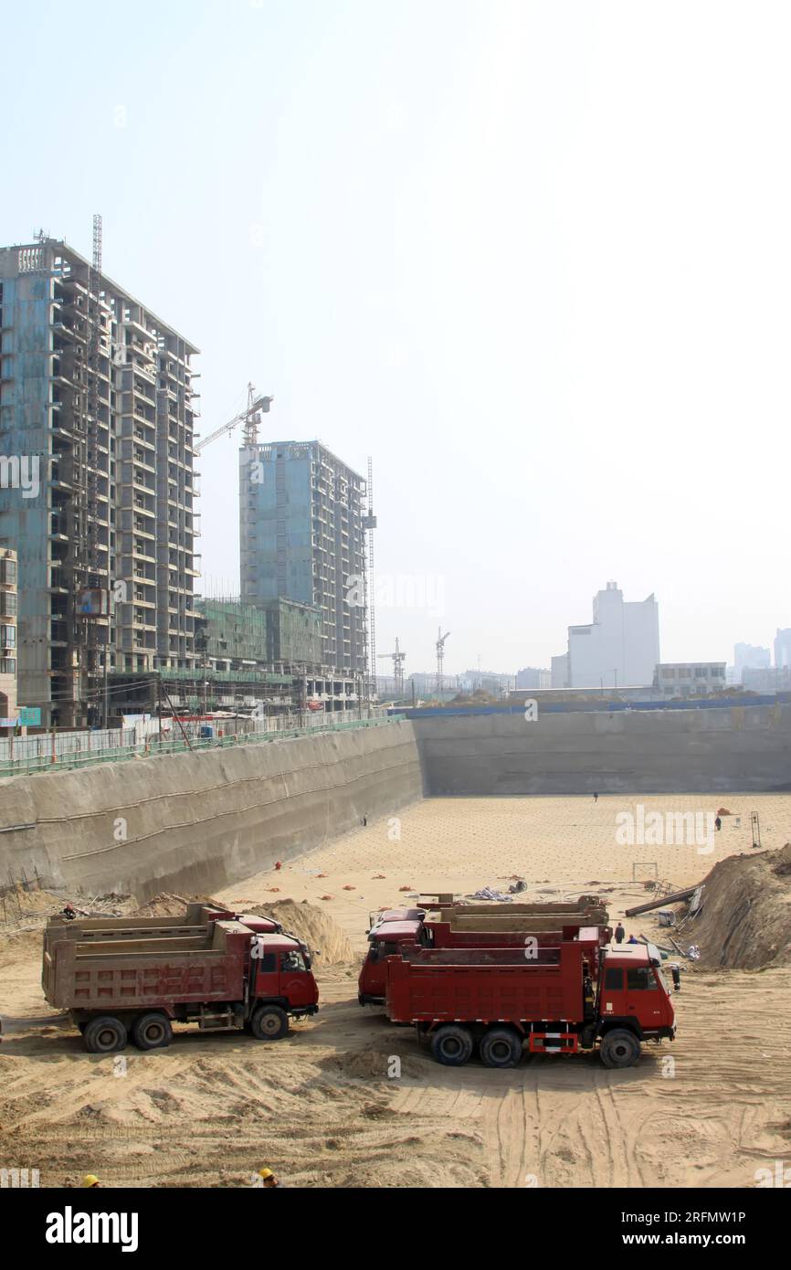 high rise buildings and trucks in a construction site, north china ...