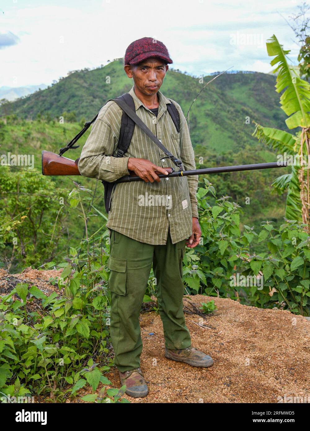 An armed volunteer from Dampi village, who is a group leader and ...