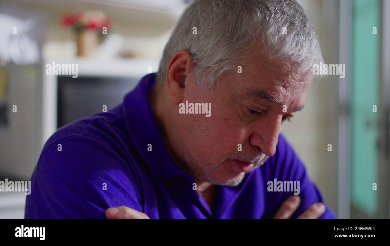 Hopeless senior man struggling with depression alone at home. Close-up ...