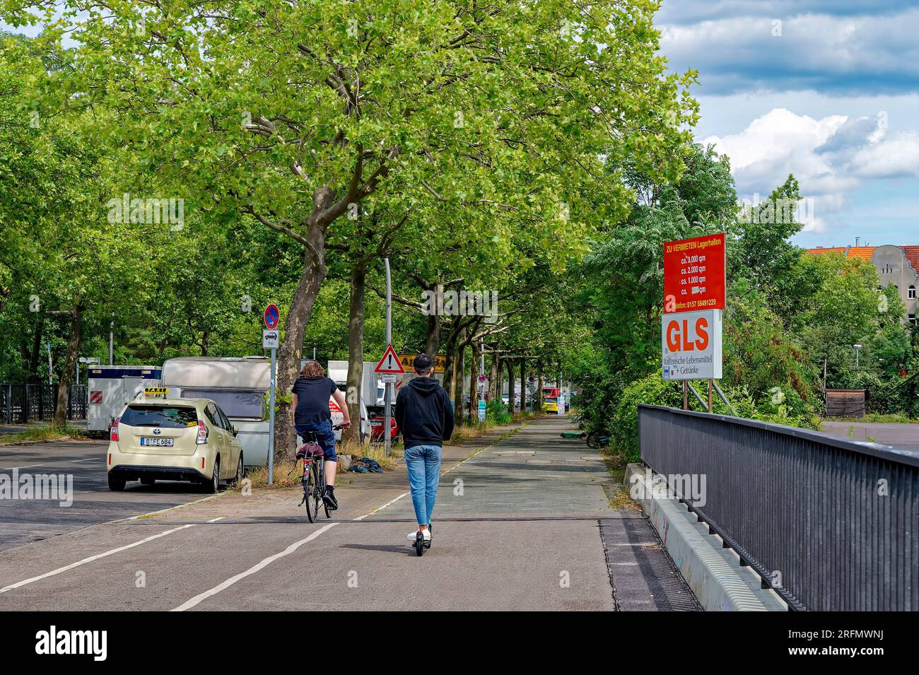 Berlin, Germany - July 30, 2023: A scooter rider riding on the sidewalk ...