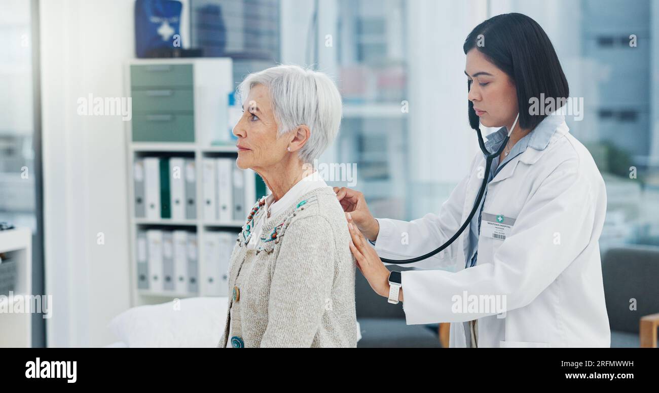 Elderly woman, doctor and stethoscope on back to listen to lungs for ...