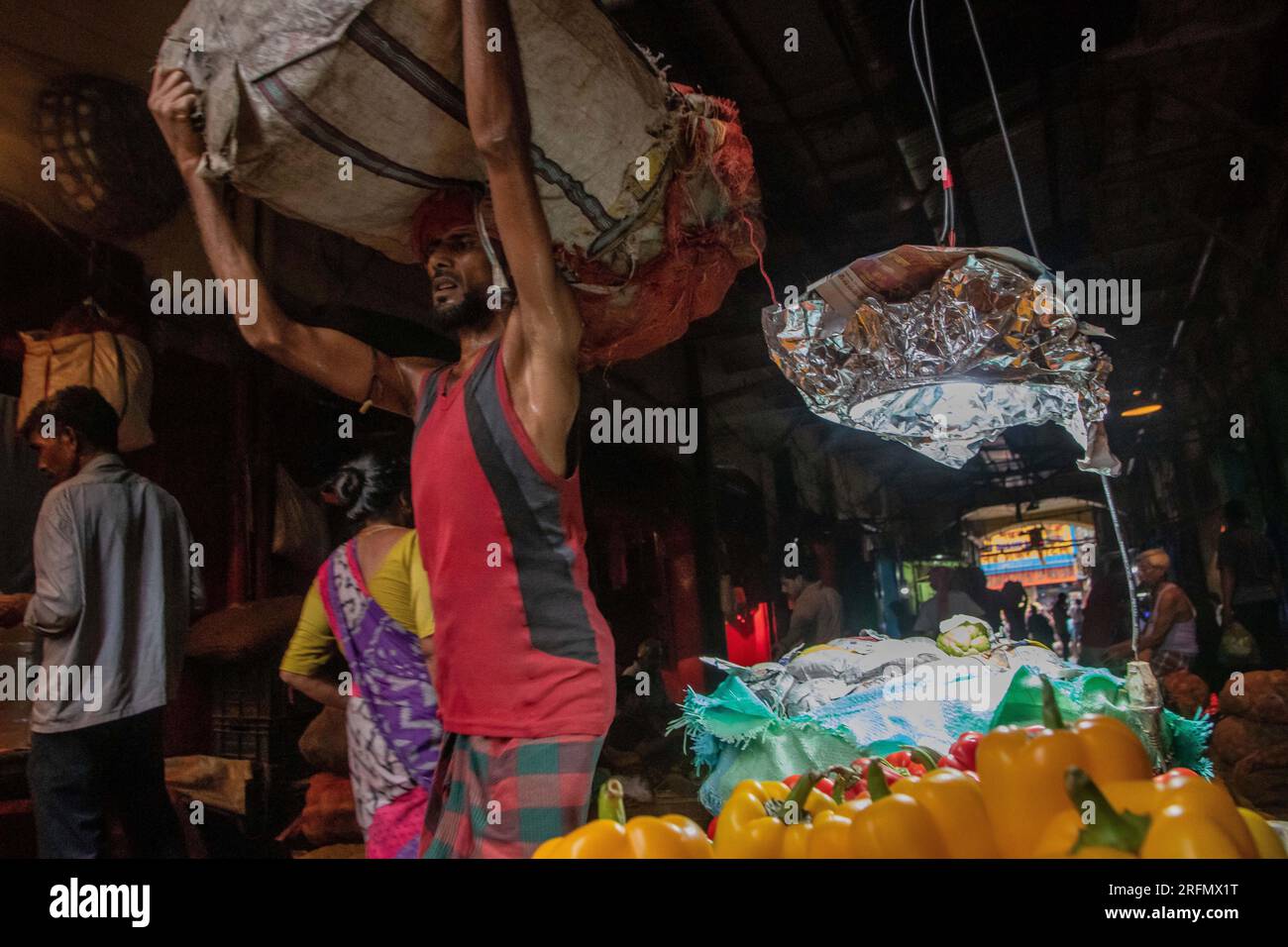 July 17,2023,Kolkata,India: Daily base Workers carry a load of ...