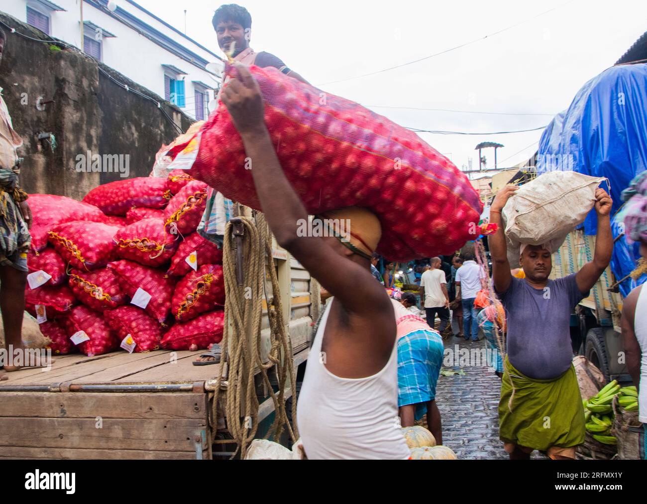 July 17,2023,Kolkata,India: Daily base Workers carry a load of ...