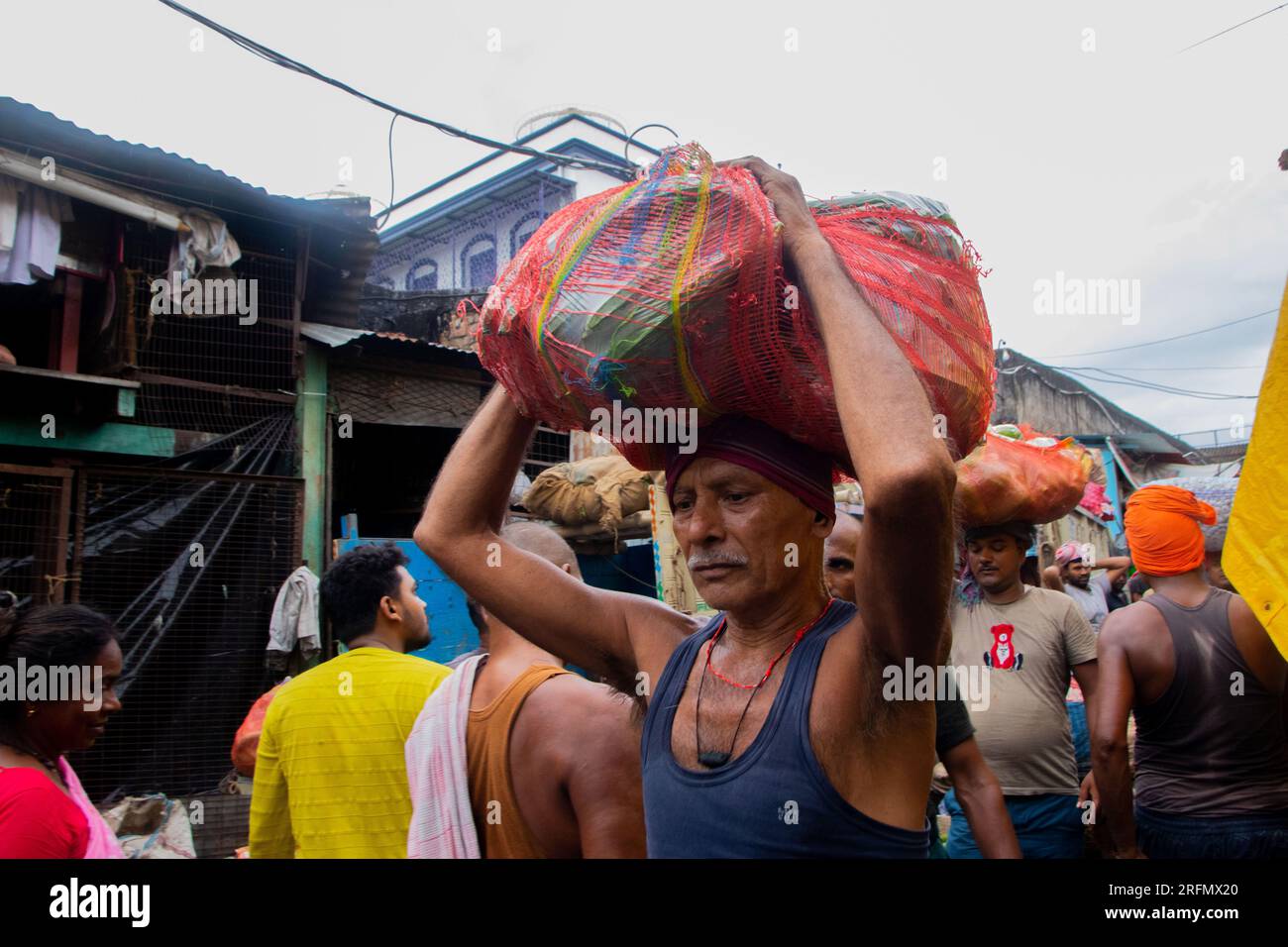 July 17,2023,Kolkata,India: Daily base Workers carry a load of ...