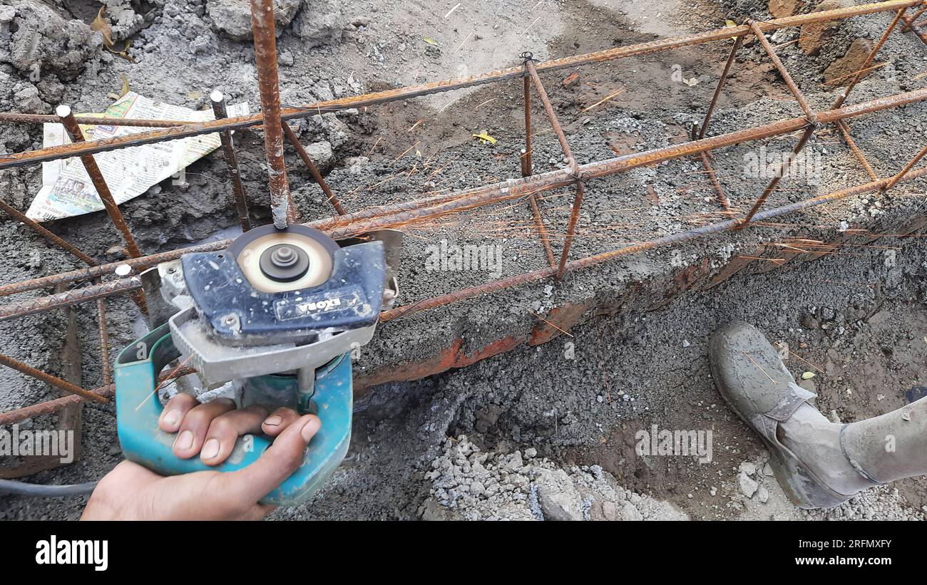 industrial engineer working on cutting a metal and steel bar with angle ...