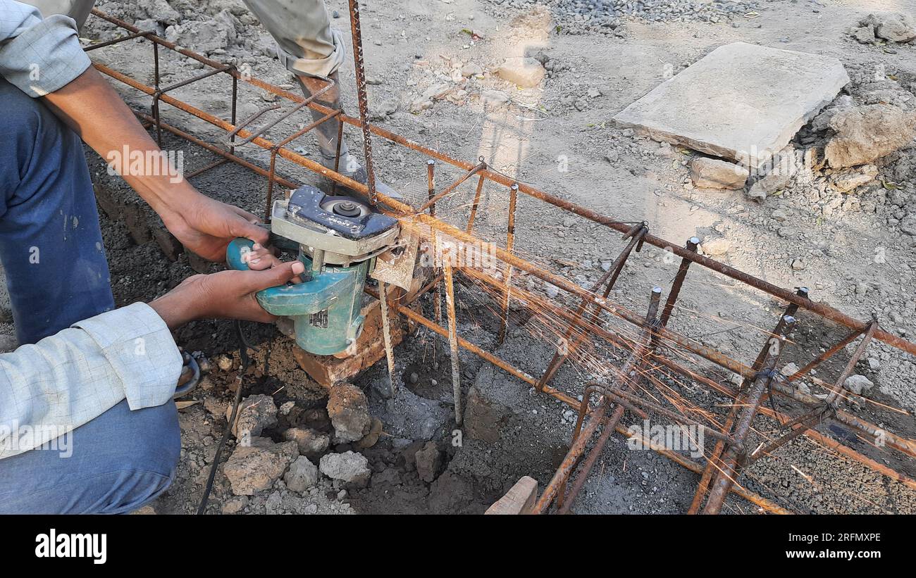 industrial engineer working on cutting a metal and steel bar with angle ...