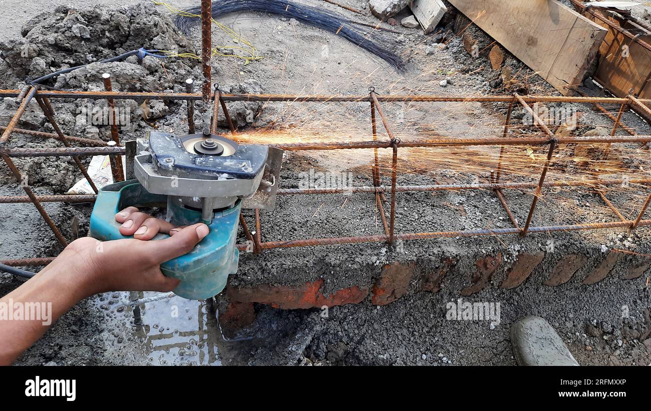 industrial engineer working on cutting a metal and steel bar with angle ...