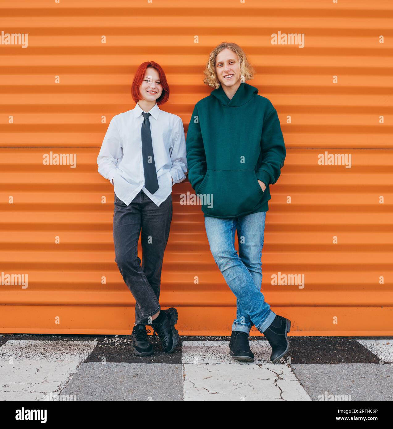 Portraits of two smiling caucasian teen friends boy and girl posing for ...