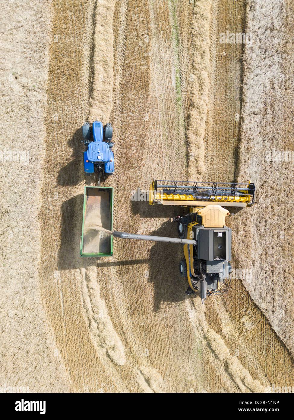 Aerial photographs of a combine harvester and tractors harvesting ...