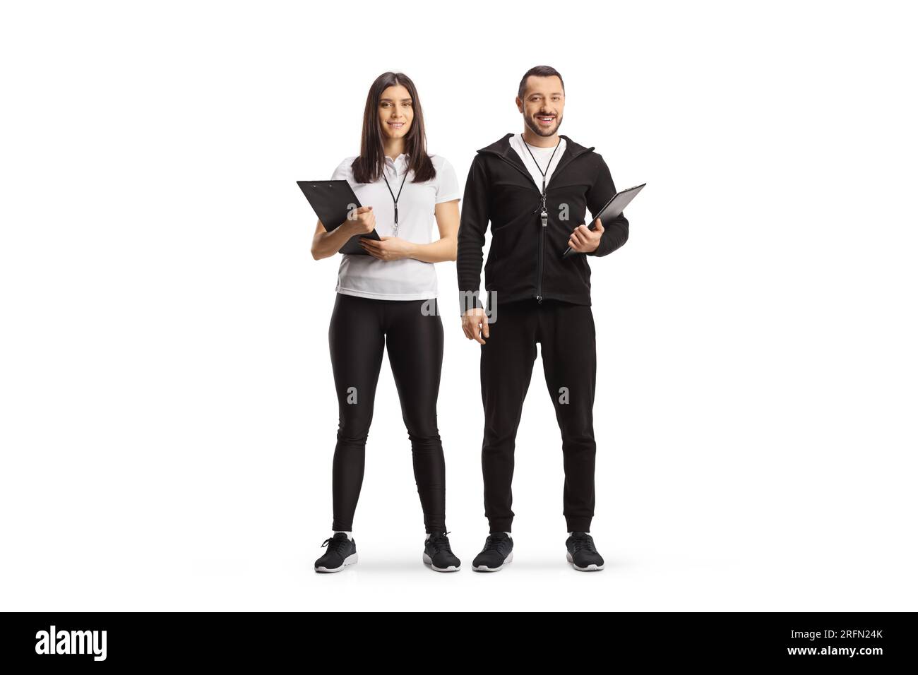 Full length portrait of a female and male sports coaches with ...