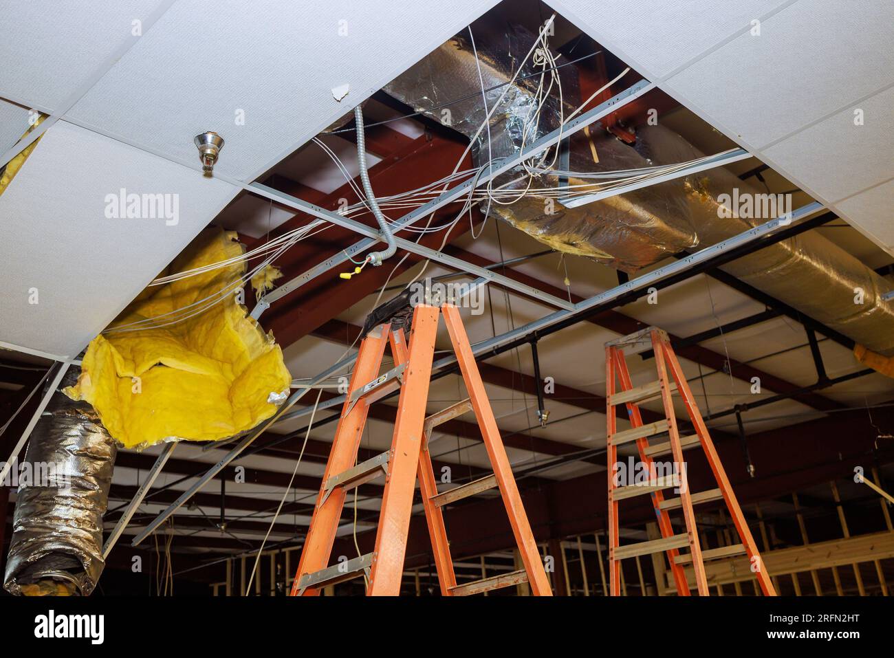 Within construction complex, ceiling works are conducted alongside ...