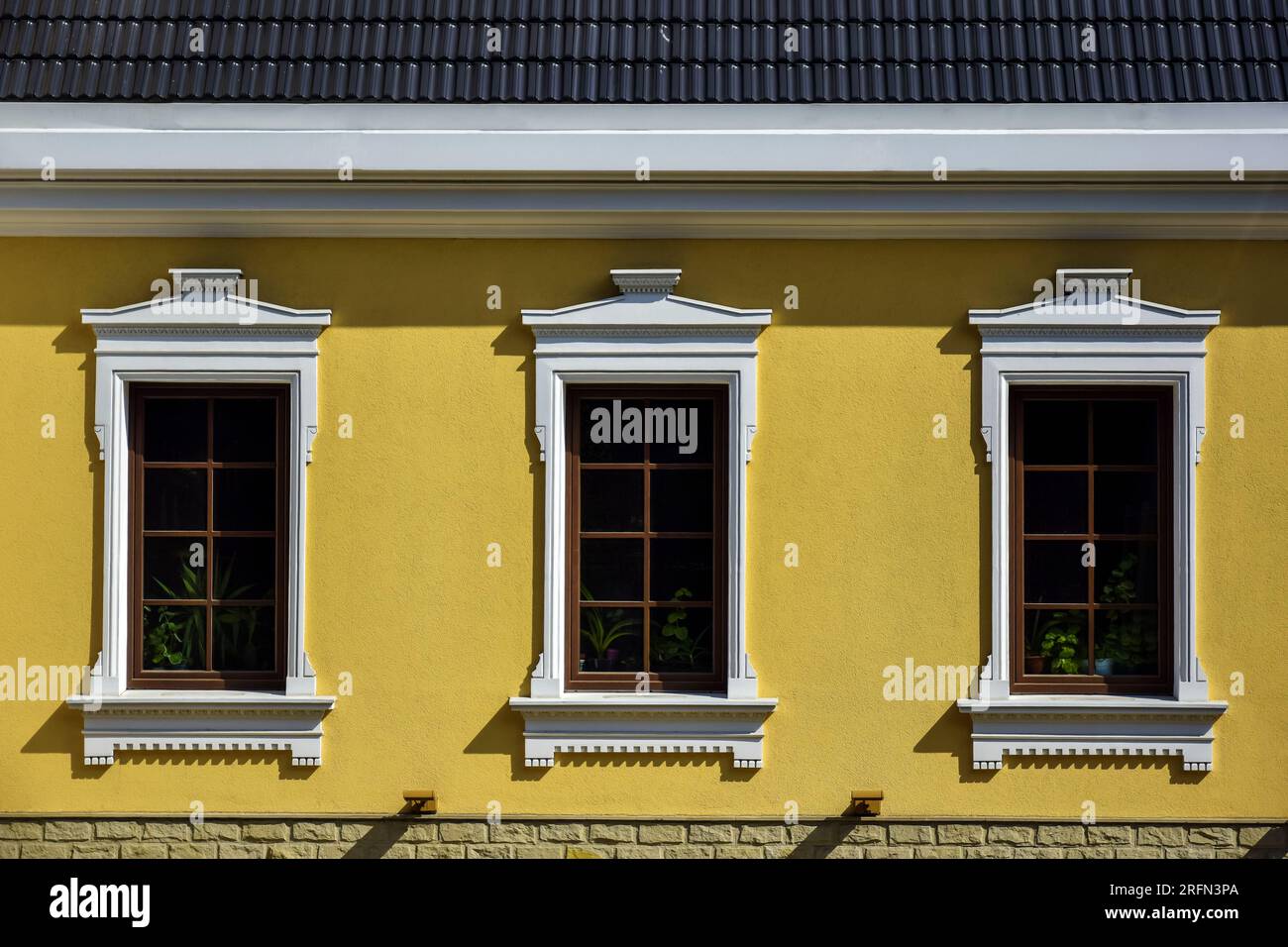 Three windows on the facade of an old yellow building. Vintage ...