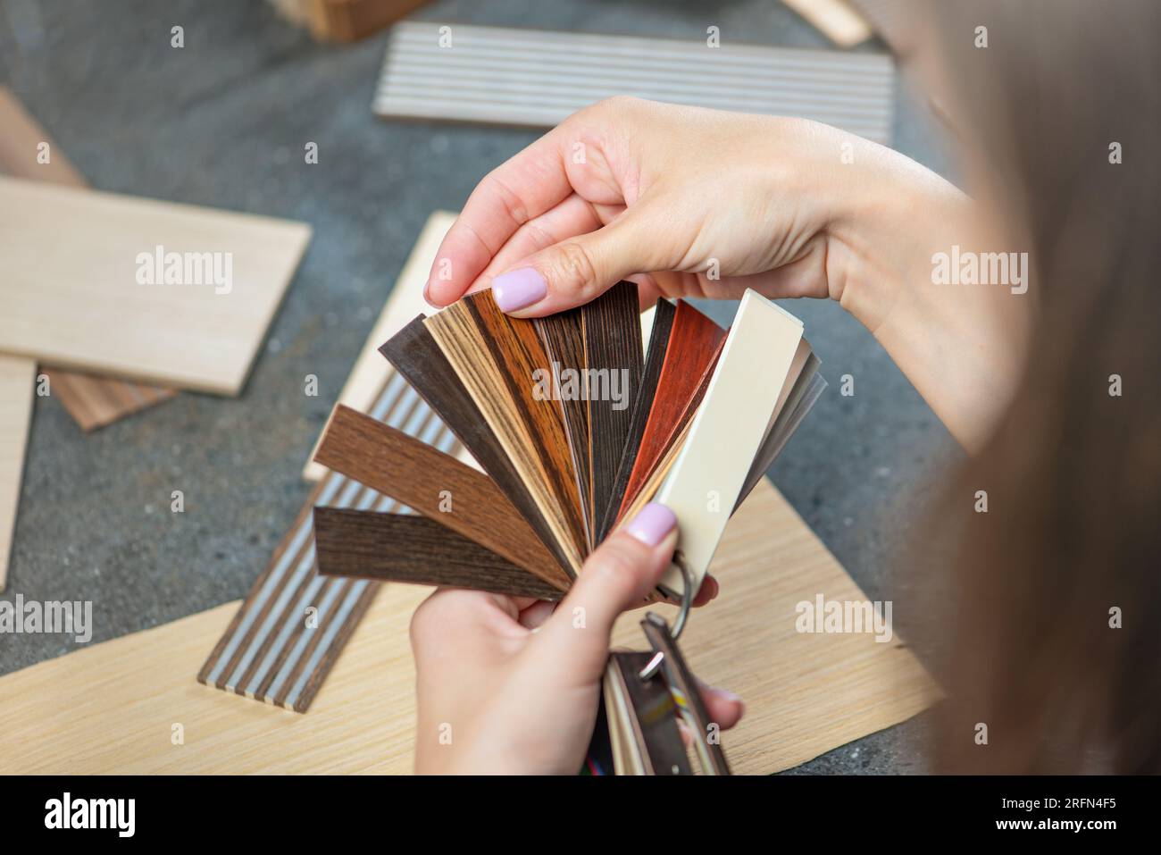 PVC edging samples close up. Women's hands hold samples of PVC edging ...