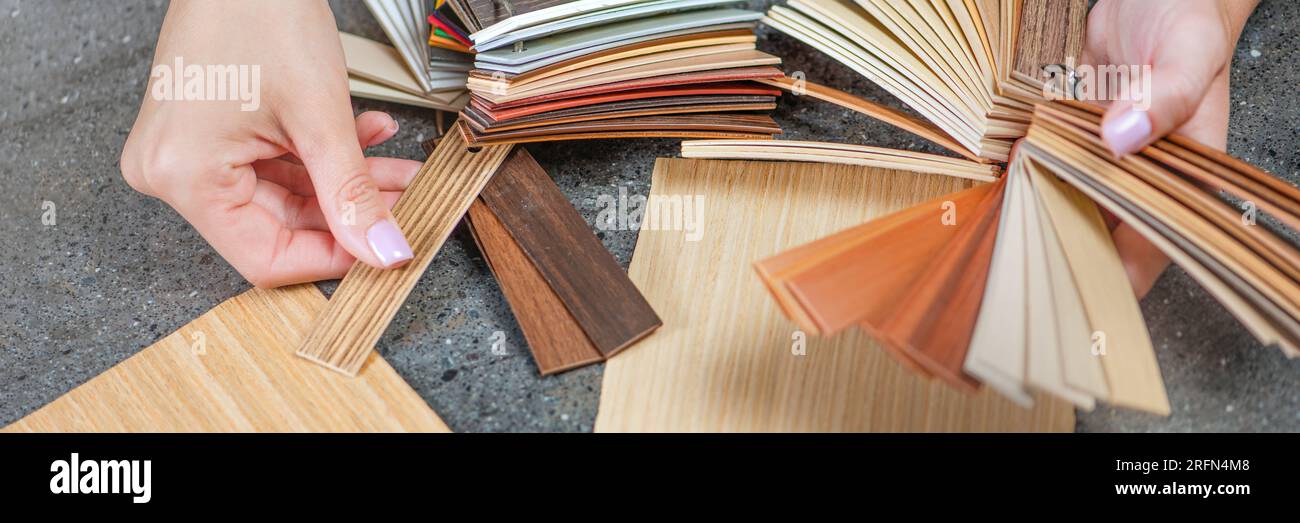 PVC edging samples close up. Women's hands hold samples of PVC edging ...