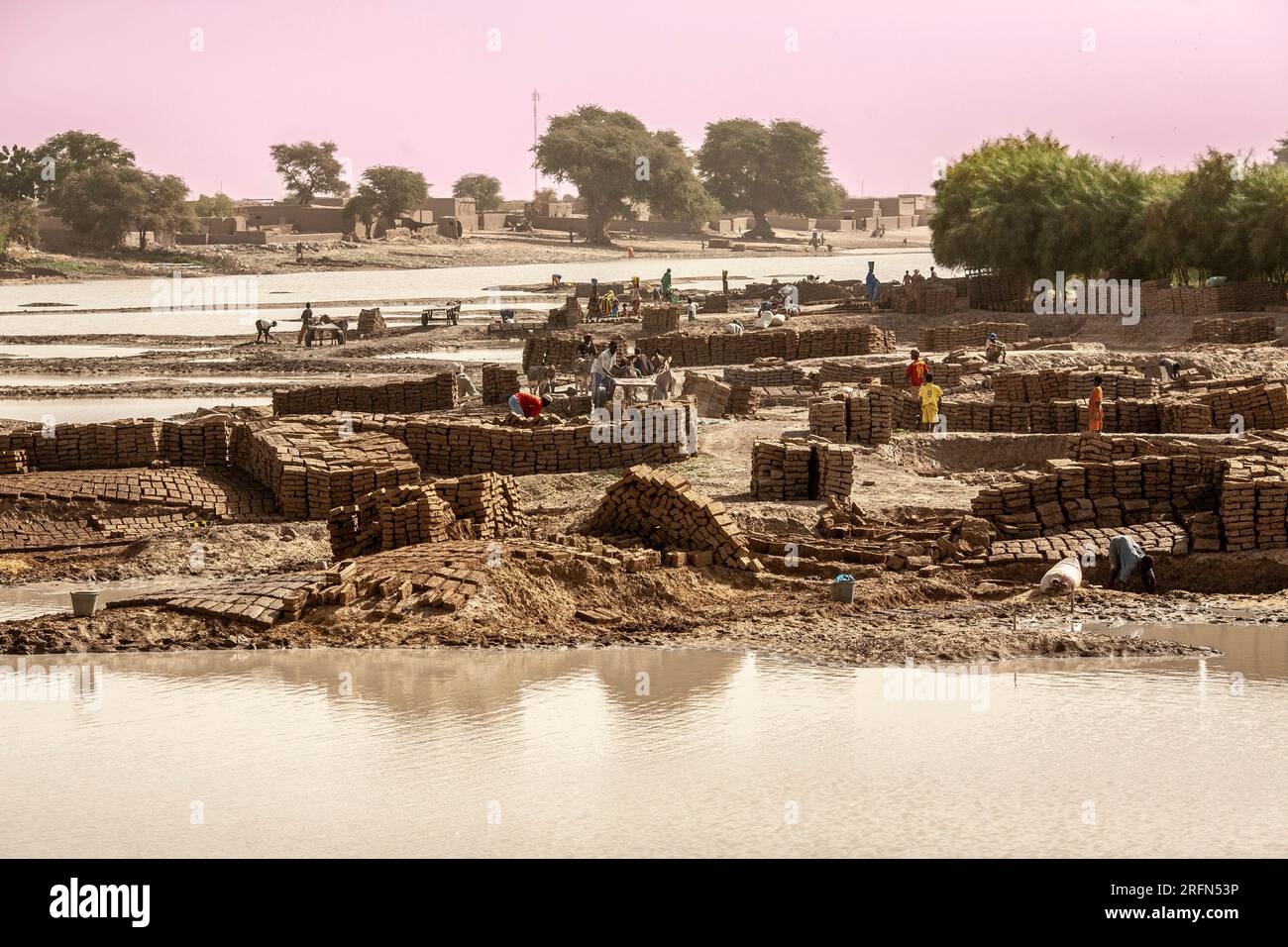 People making traditional adobe mud bricks - workers make clay brick ...