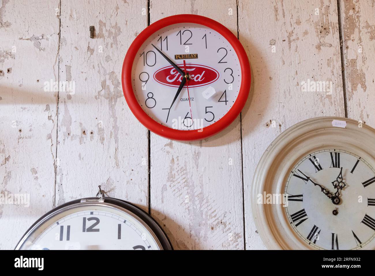 Signs and symbols, a flea market, a wall clock with a Ford emblem on it ...