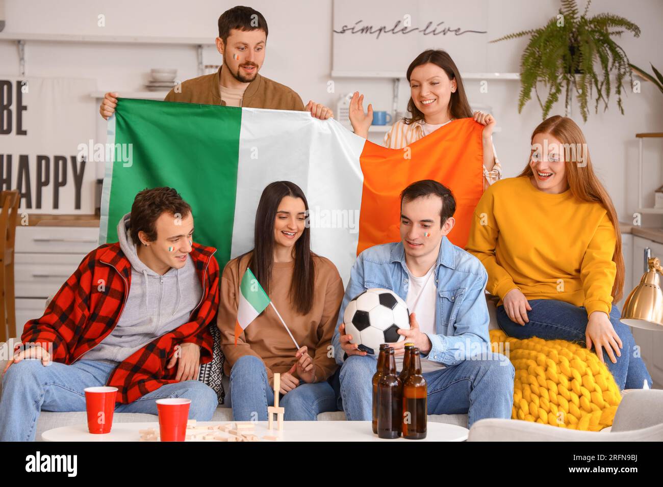 Group of friends with soccer ball and flags of Ireland at home Stock ...