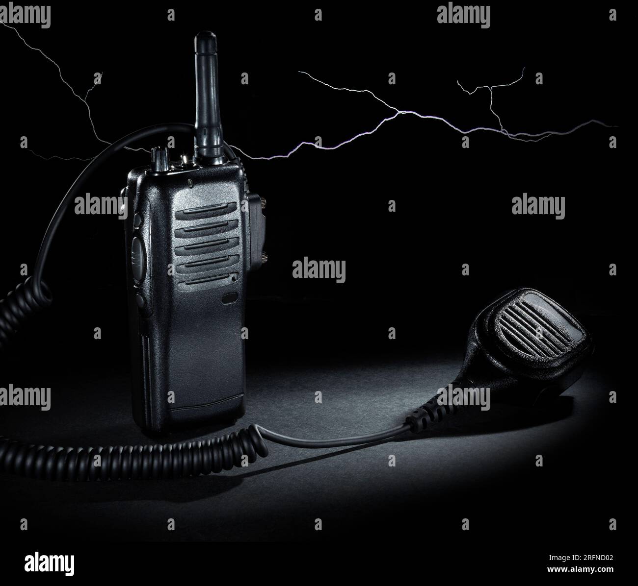 Handheld two way radio and microphone with lightning behind Stock Photo ...