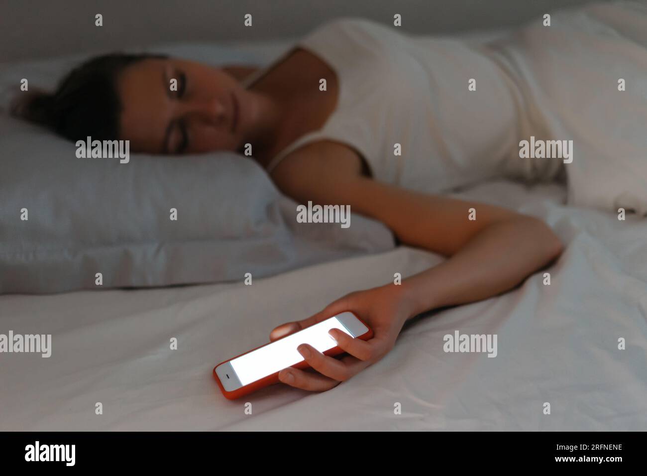 Young woman fell asleep with smartphone lin her hand. Phone addiction ...