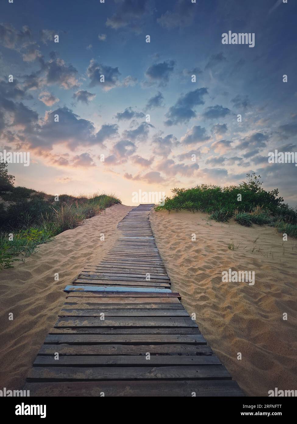 Wooden pathway through the sand leading to the beach. Beautiful morning ...