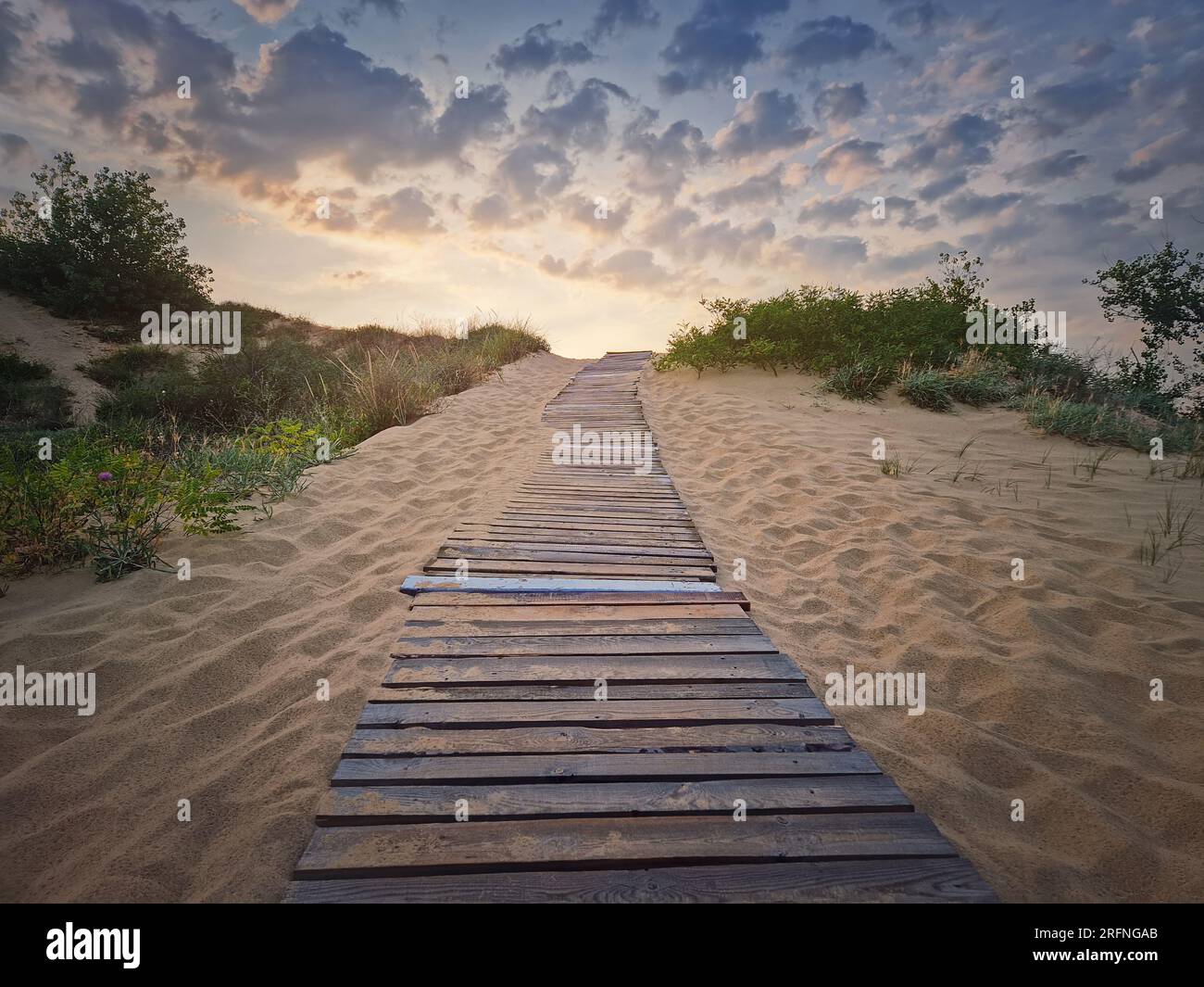 Wooden path through the sand leading to the beach. Beautiful morning ...