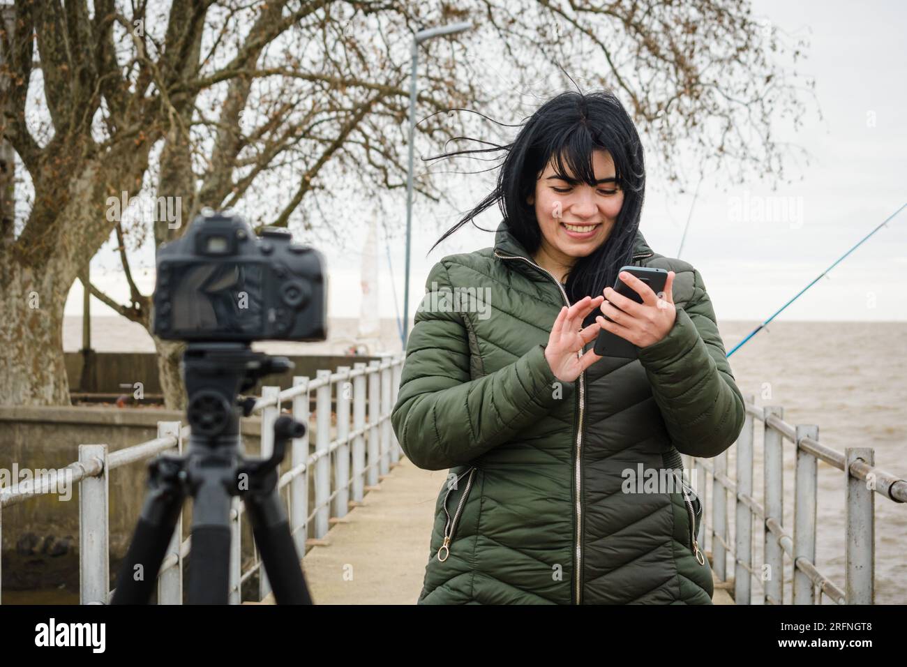 young latin woman traveler content creator smiling taking photos and ...