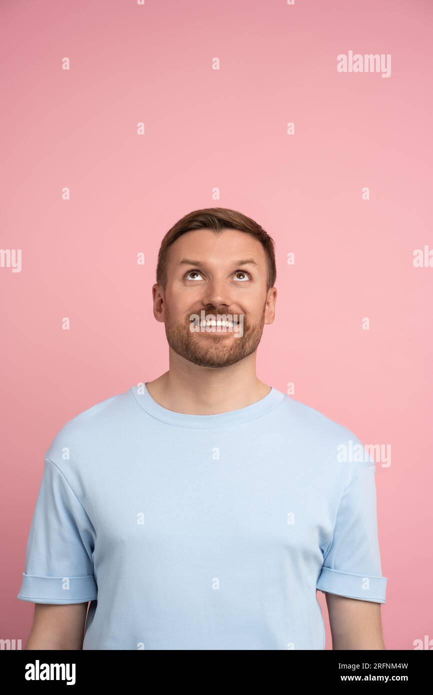 Thoughtful smiling guy dreamer creating crazy ideas for lifestyle ...