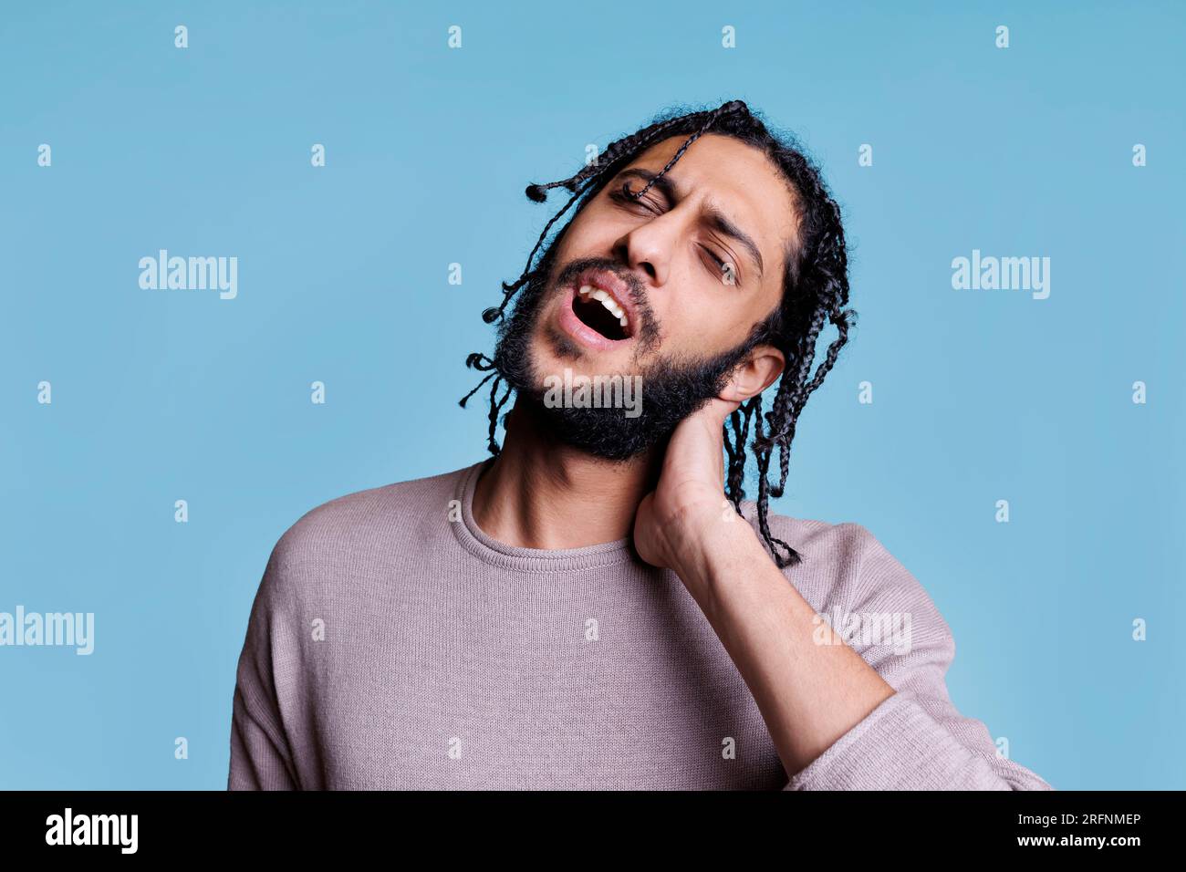 Arab young man making self massage for headache neck pain. Exhausted ...