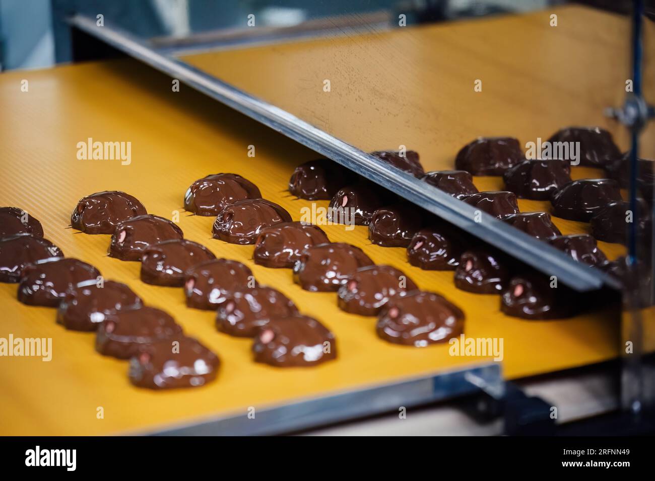 Process of chocolate glazing zephyr marshmallows in confectionery on ...