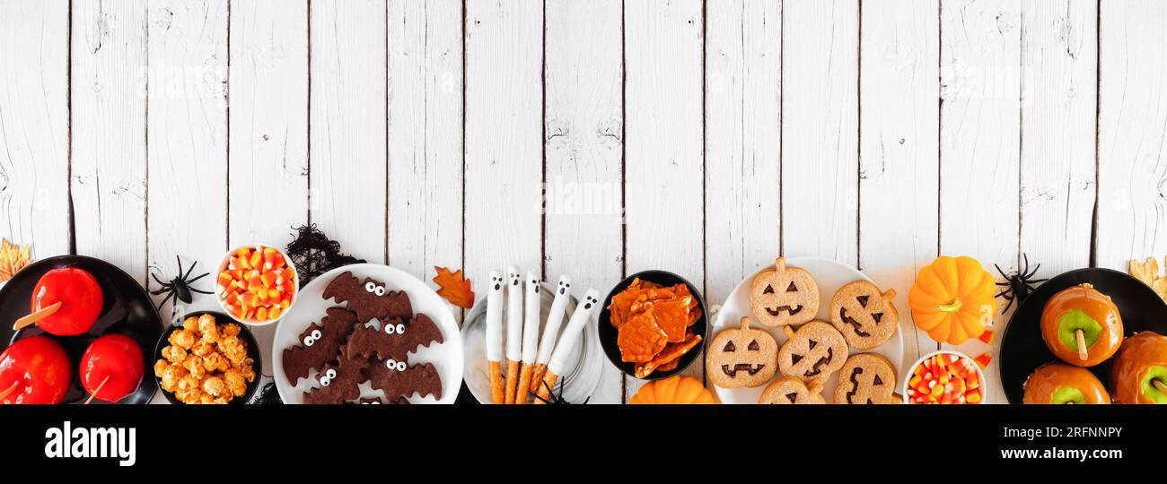 Traditional Halloween treat bottom border over a white wood banner ...