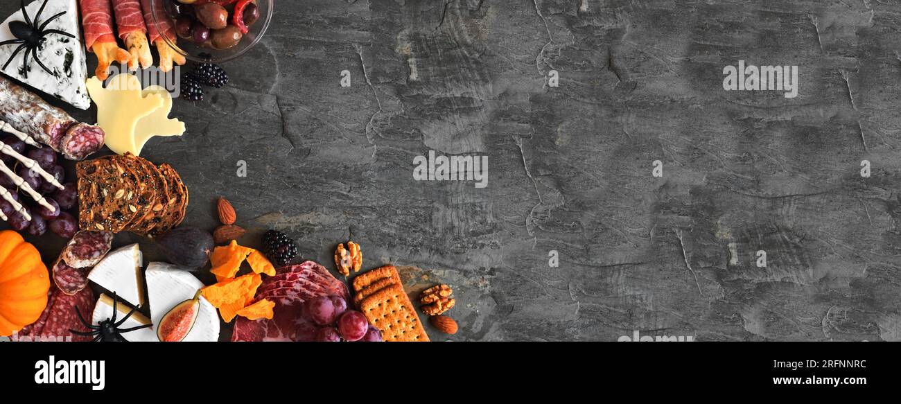 Halloween themed charcuterie corner border against a dark stone banner ...