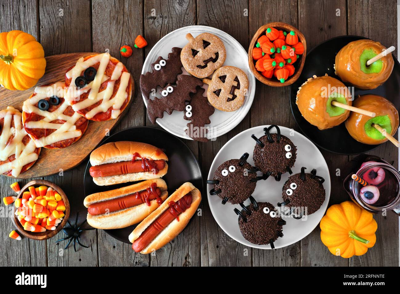 Halloween party food table scene over a rustic wood background ...