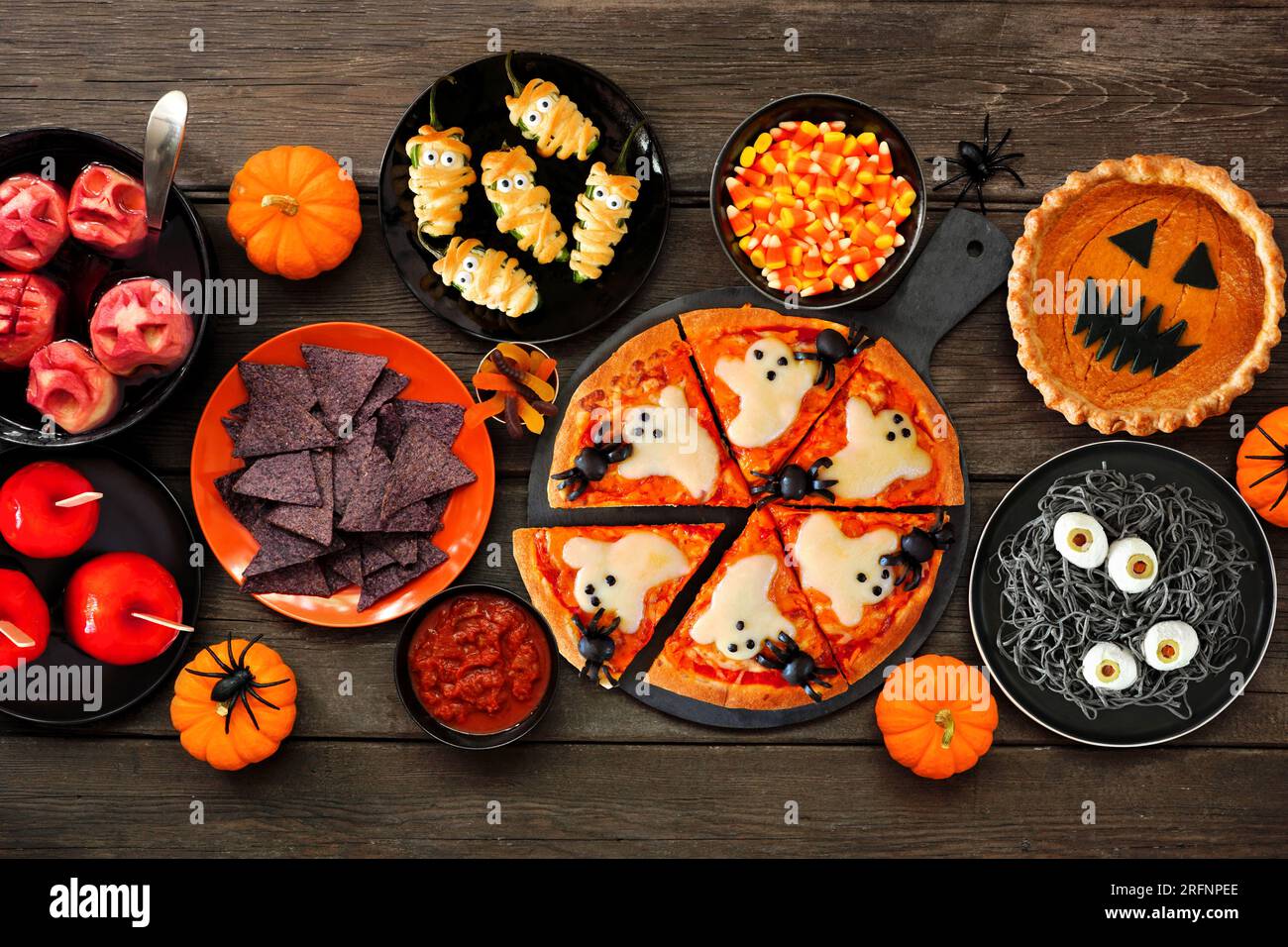 Fun Halloween dinner party table scene over a dark wood background. Top ...