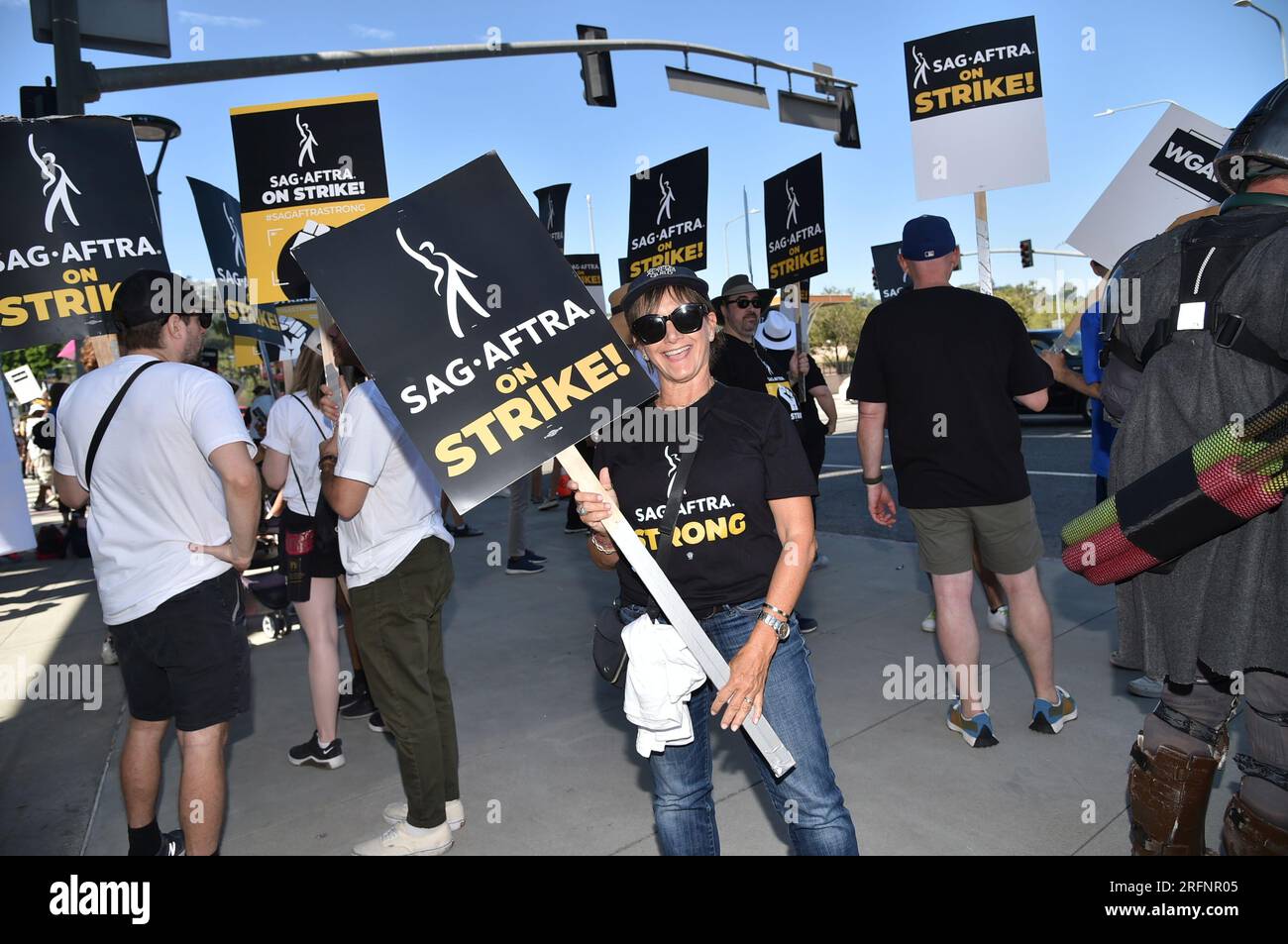 Picketers carry signs on the picket line outside Universal Studios on ...