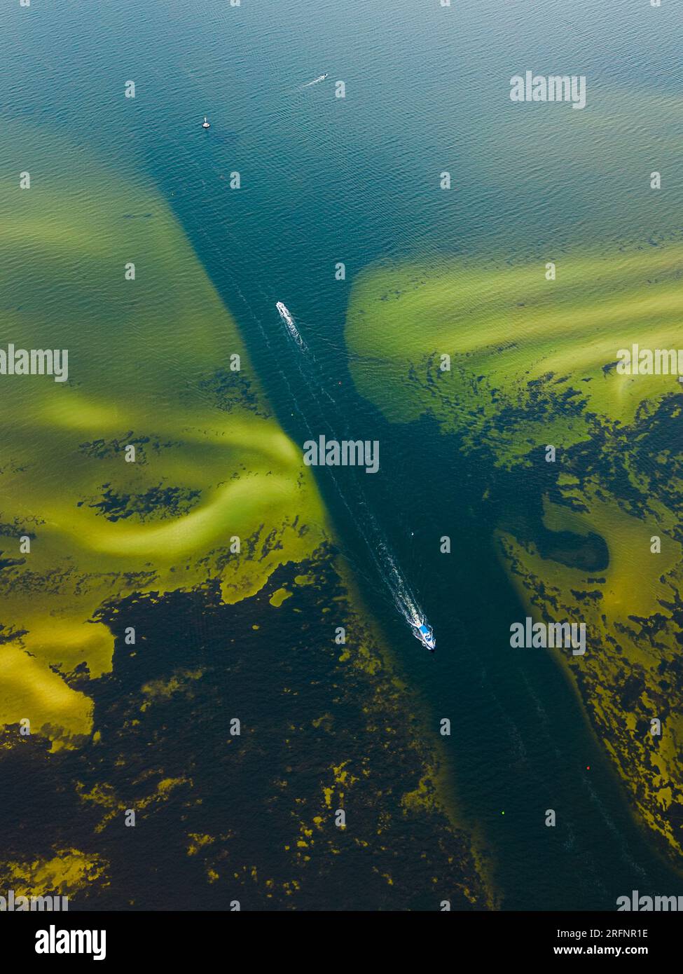 motor boat sailing in open polluted water of sea or ocean, aerial view ...