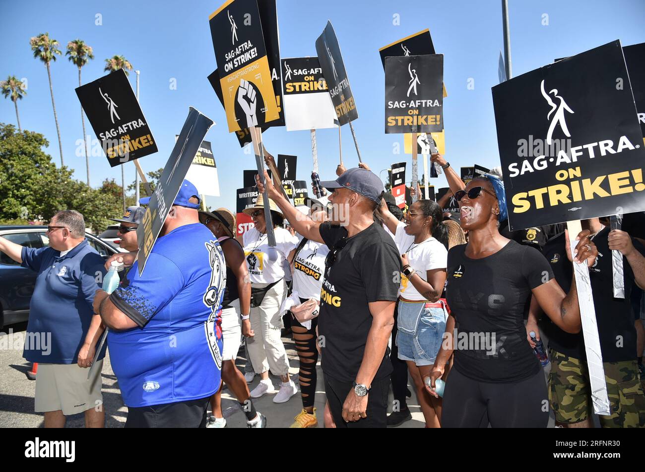 Picketers carry signs on the picket line outside Universal Studios on ...
