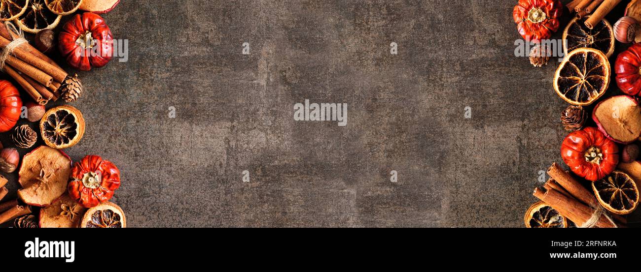 Autumn baking spices and ingredients. Double border on a dark stone ...