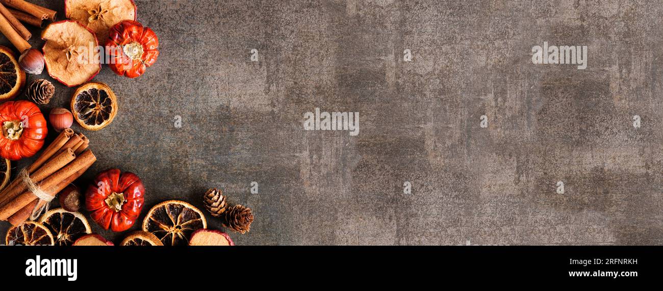 Fall theme baking spices and ingredients. Corner border on a dark stone ...