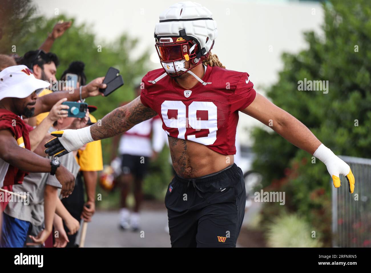 Washington Commanders Defensive End Chase Young (99) high fives fans as ...