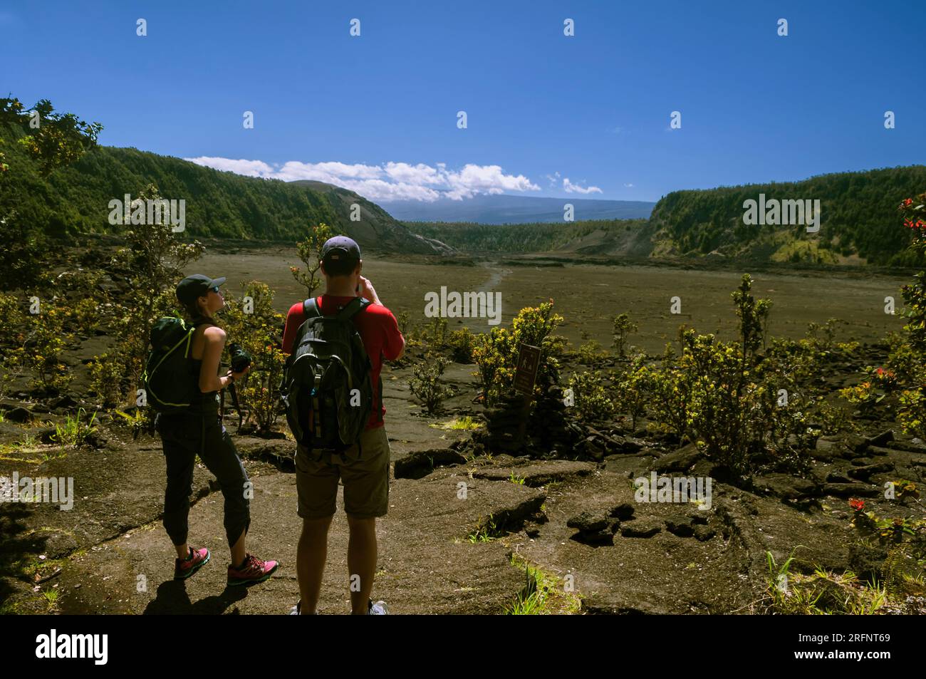 A couple of hikers, a male and a female, at the Volcanos National Park ...