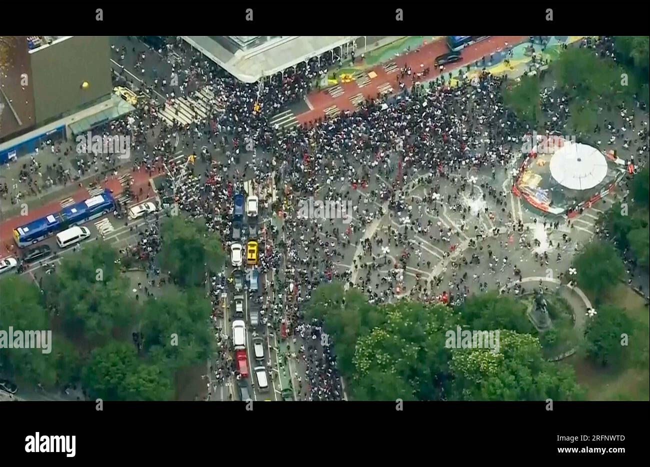 In this photo taken from video provided by WABC7, a crowd moves through ...